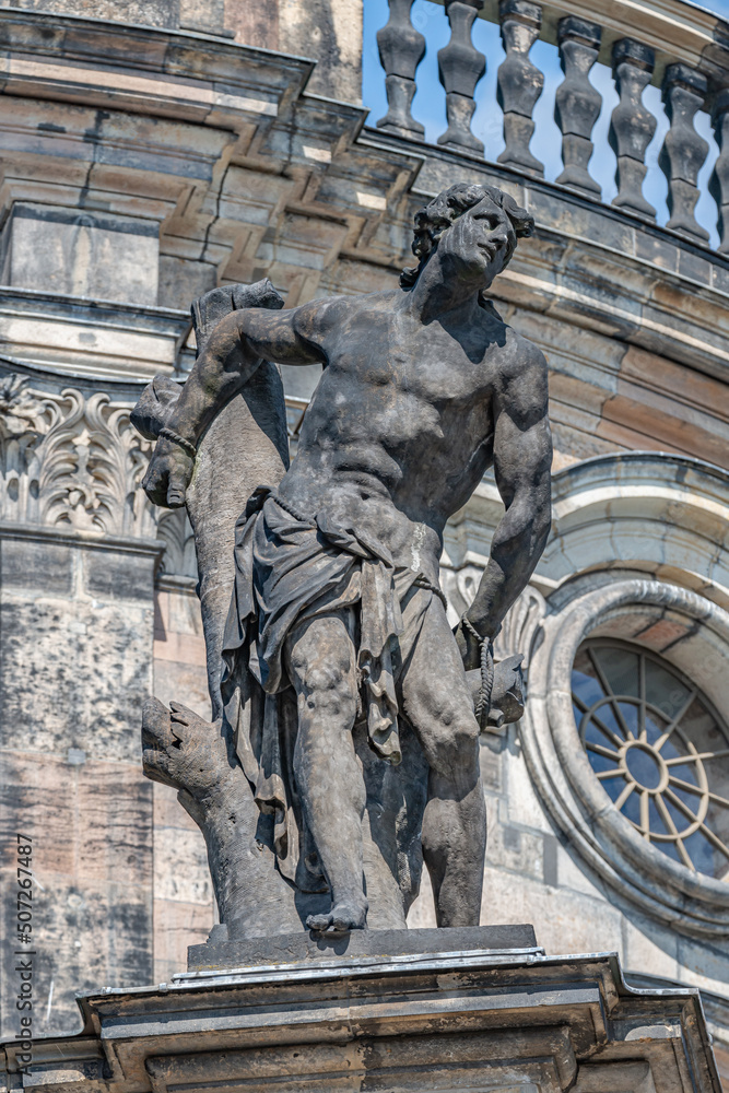 Old statue of a man in slavery in downtown of Dresden, Germany, details ...