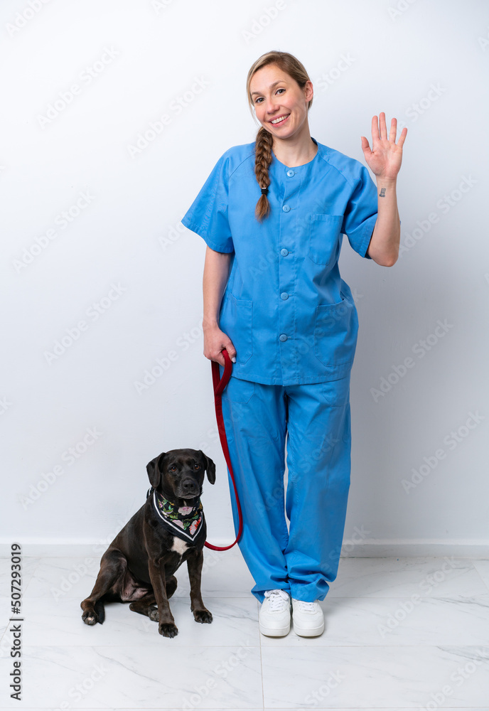 Full body veterinarian woman with a dog isolated on white background ...