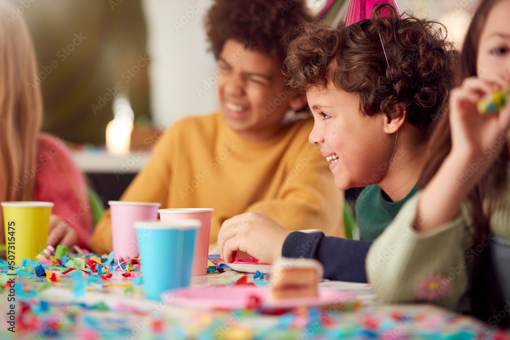 Children Sitting At Table Friends Celebrating At Birthday Party With ...