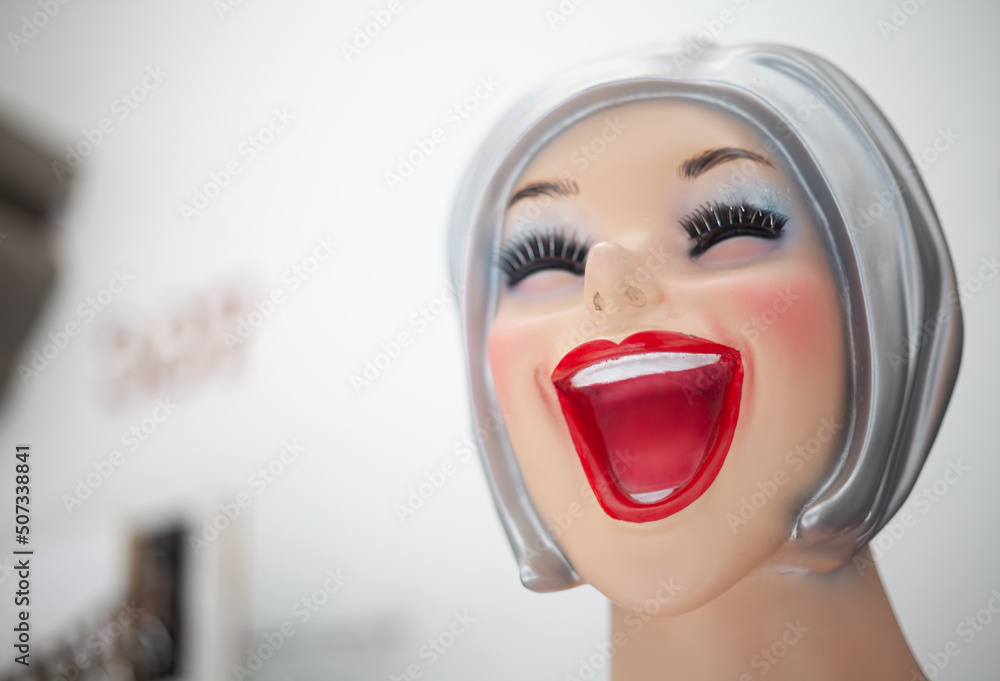 smiling face of an expressive mannequin in the store window of a ...