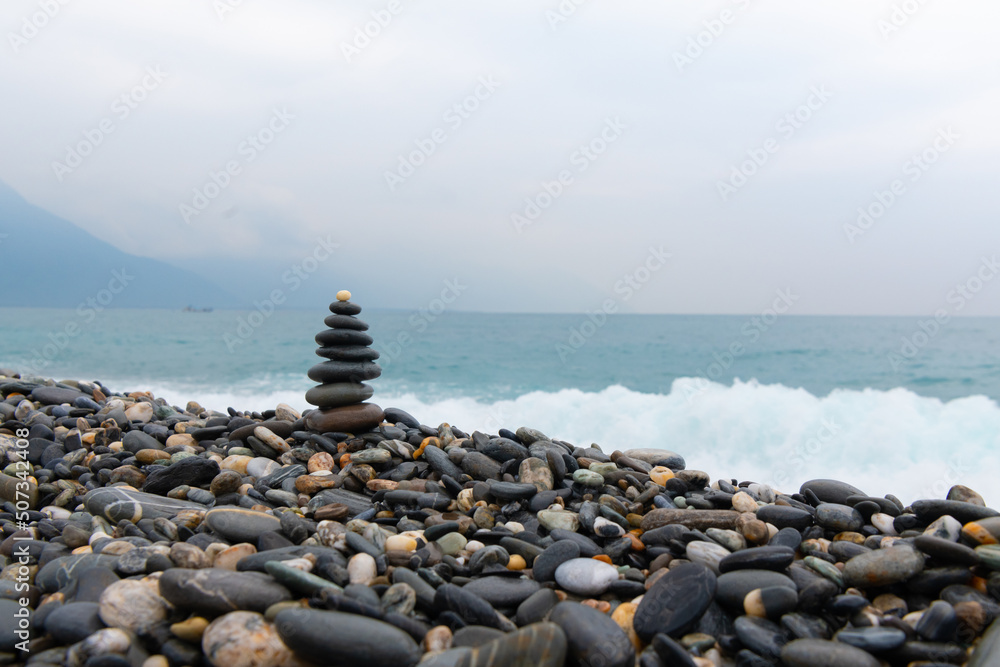 stacked stones, tower or pyramid of stones on the beach, balance, Sea ...