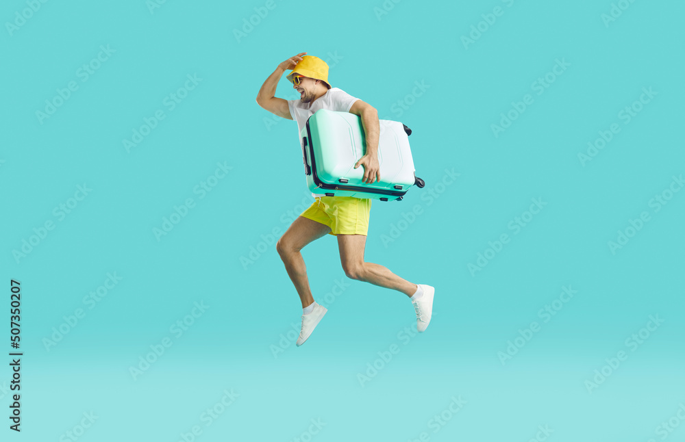 Funny traveler excited about summer holiday jumping high in air. Happy ...