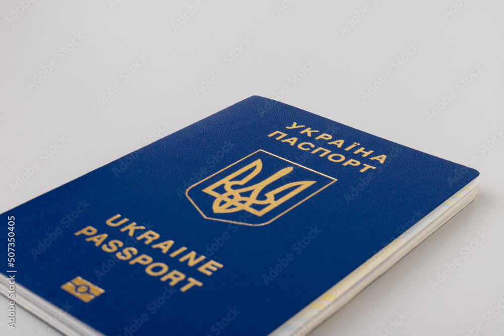 Ukrainian passport with a golden trident symbol on light background ...
