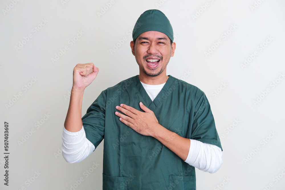 Asian hospital nurse clenched fist while one hand touching his chest ...