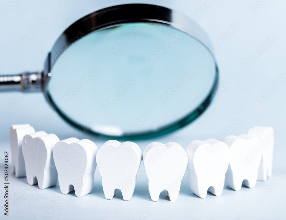 Teeth in smile form with magnifying glass. Dental checkup, tooth, gums ...