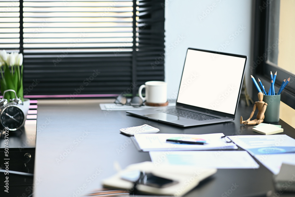 Modern office with computer laptop, stationery and financial documents ...