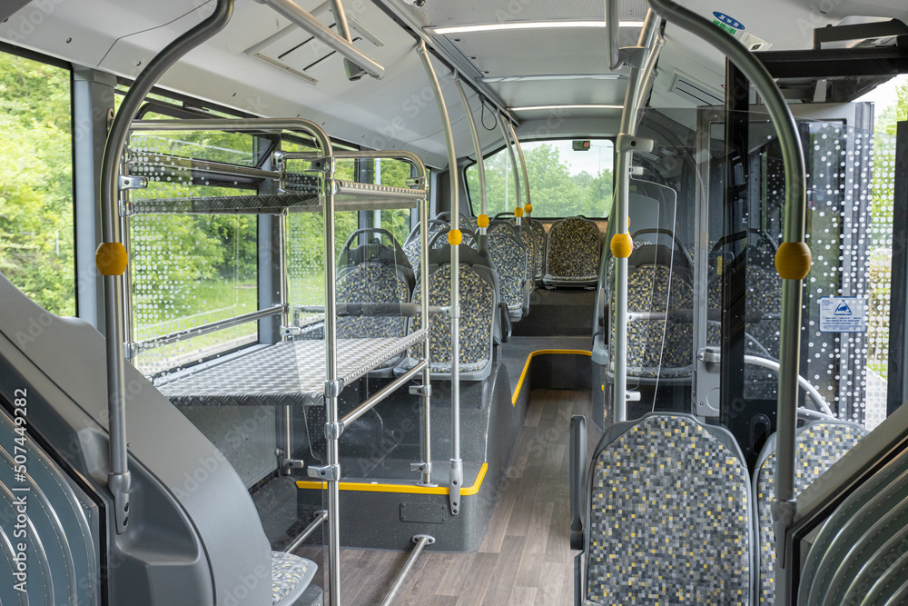 Inside London Stansted airport bus. Empty seats, open door and luggage ...