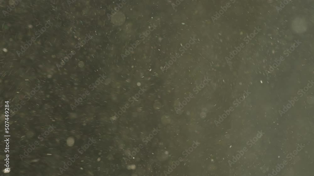 Slow motion explosive flow of dust particles in air with natural back ...