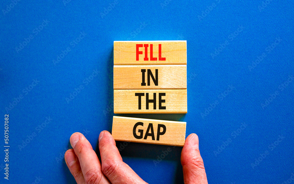 Fill in the gap symbol. Concept words Fill in the gap on wooden blocks on a beautiful blue table ...