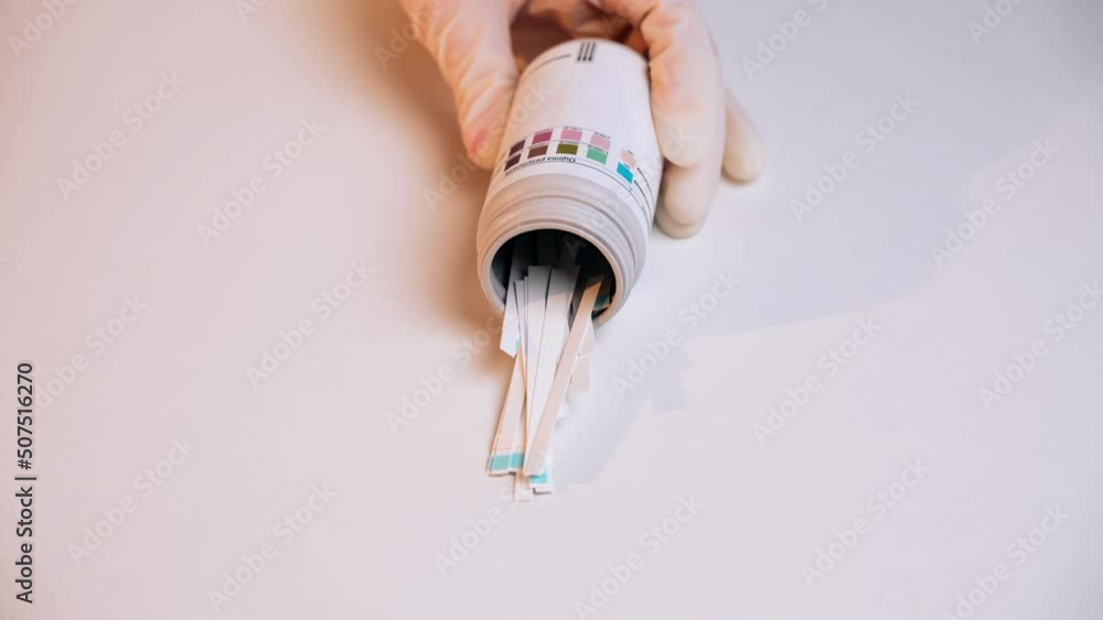 Close-up of hand in disposable medical glove pour out test strips from ...