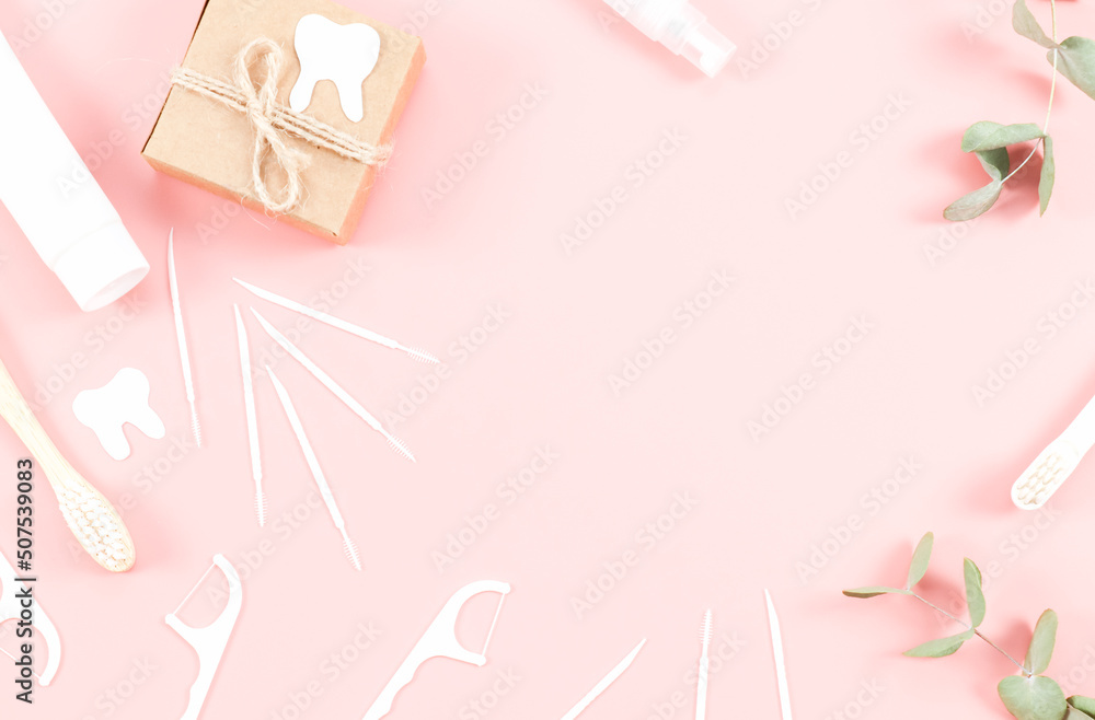 Bamboo toothbrush, dental floss, toothpicks, tube of toothpaste, paper ...