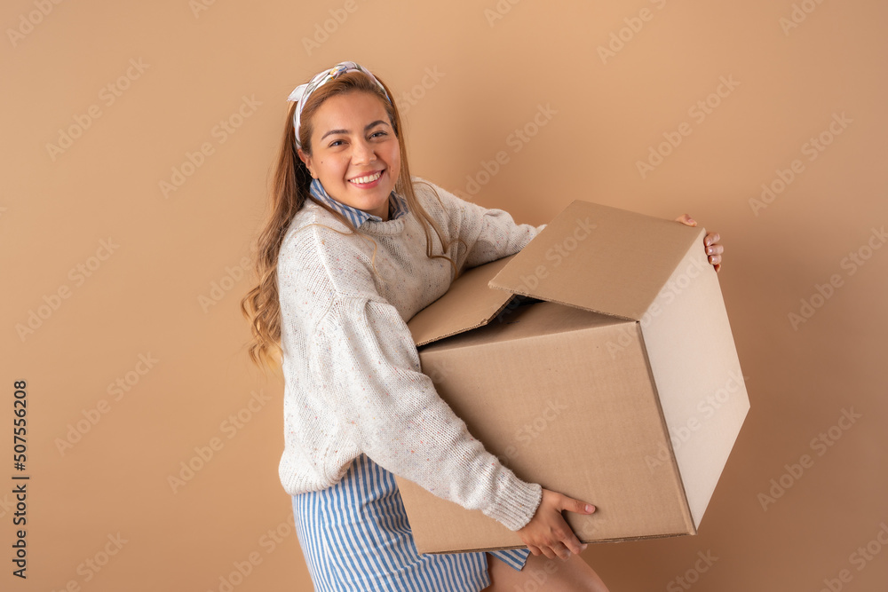 Beautiful attractive young woman posing happily and holding a heavy ...