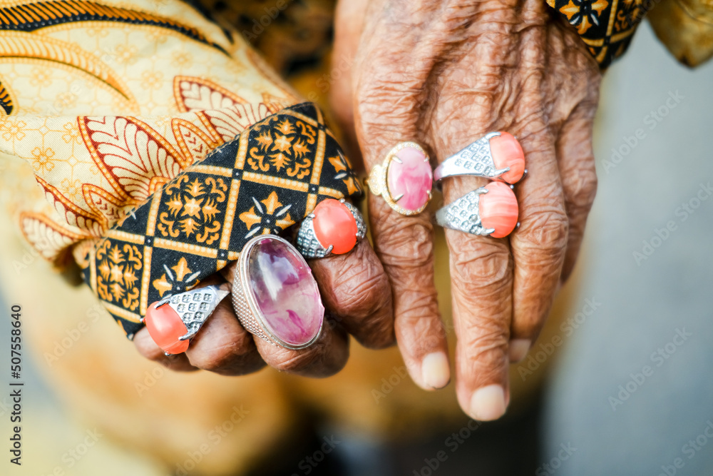 old man showing off a collection of agate rings Stock Photo | Adobe Stock