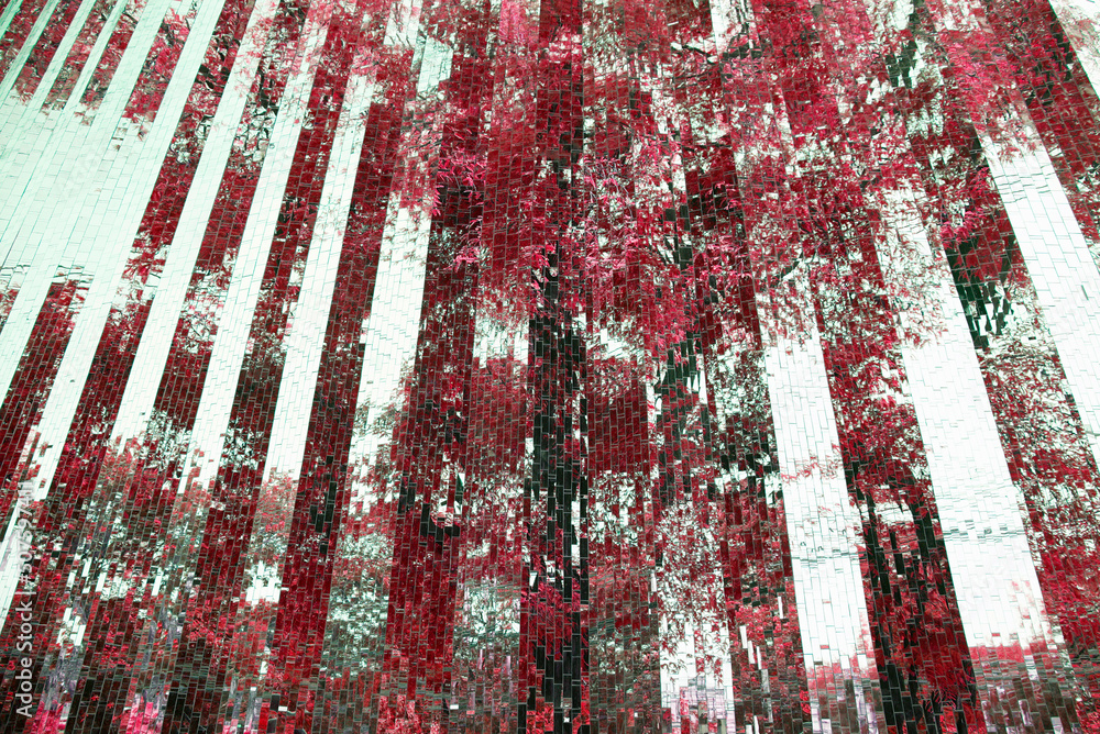 Red color reflects of the tree on many rectangular mirrors. The image ...