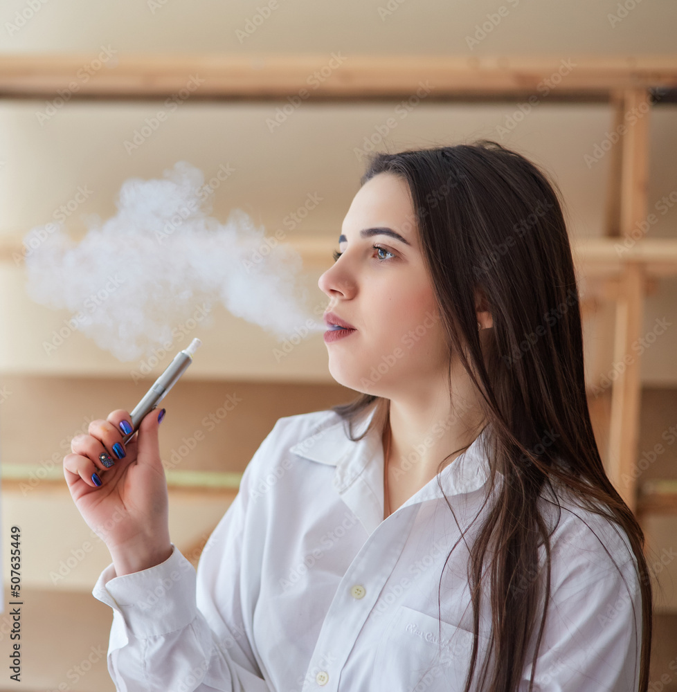 Modern girl smoking vape.Trendy new vaping device,smoke e-liquid ...