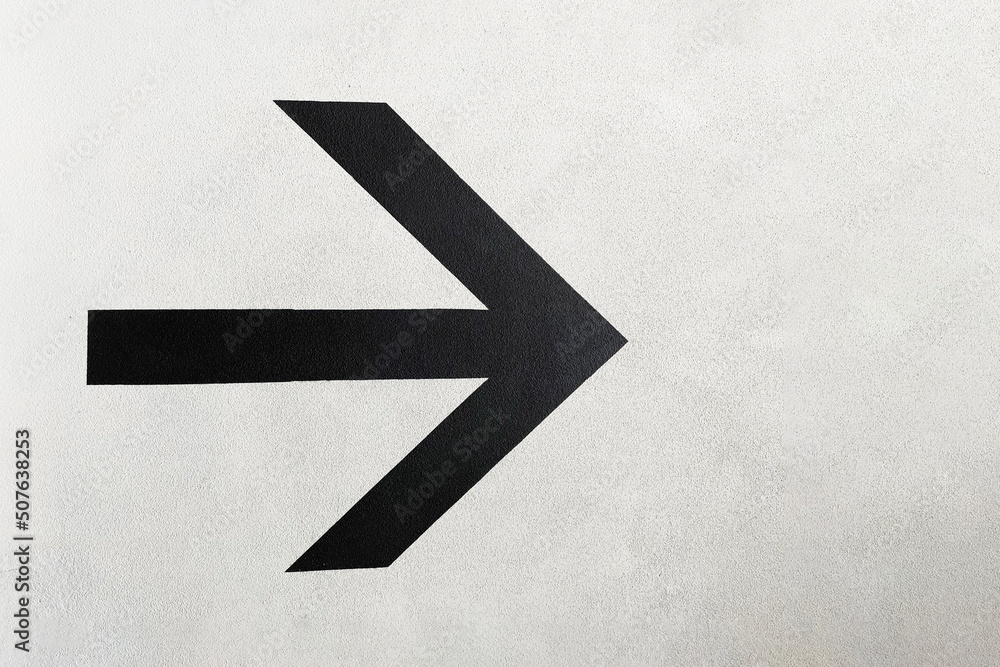 arrow direction on a white wall, black direction arrow on a white ...