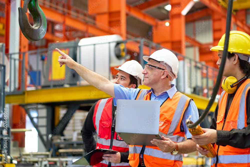 Foreman lead team to checking safety in metal sheet factory with laptop ...