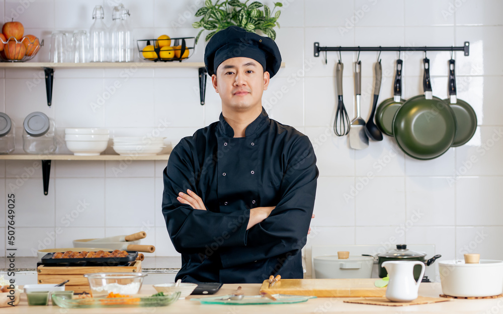 Foto de Portrait handsome professional Japanese male chef wearing black ...