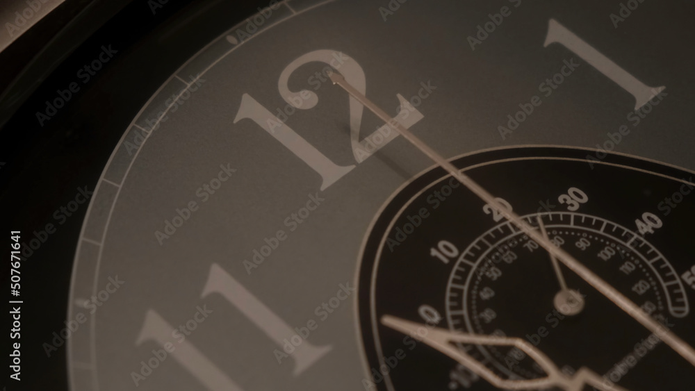 Close up of clock detail with moving hand close to 12 hours, concept of ...