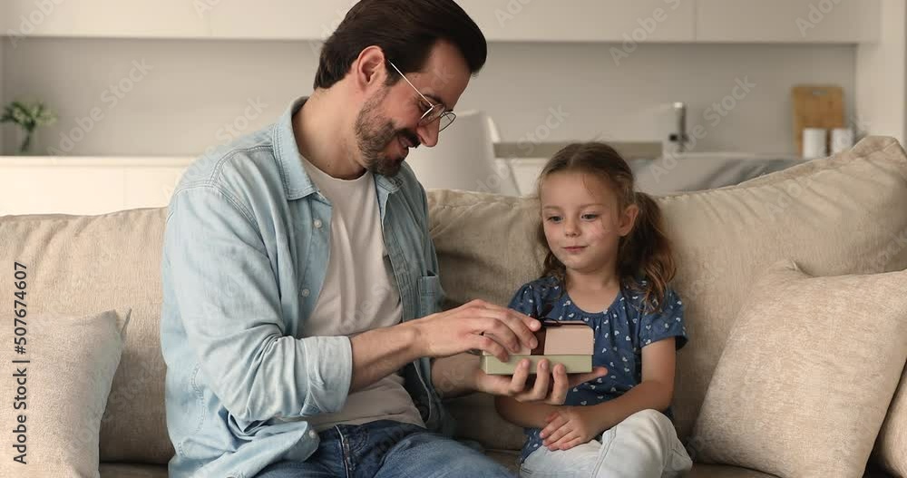 Affectionate loving young father getting present wrapped in box form ...
