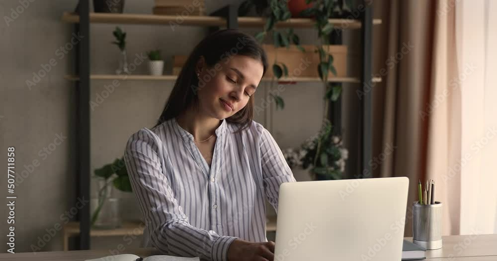 Pretty young woman clerical worker accomplish work on laptop feeling ...