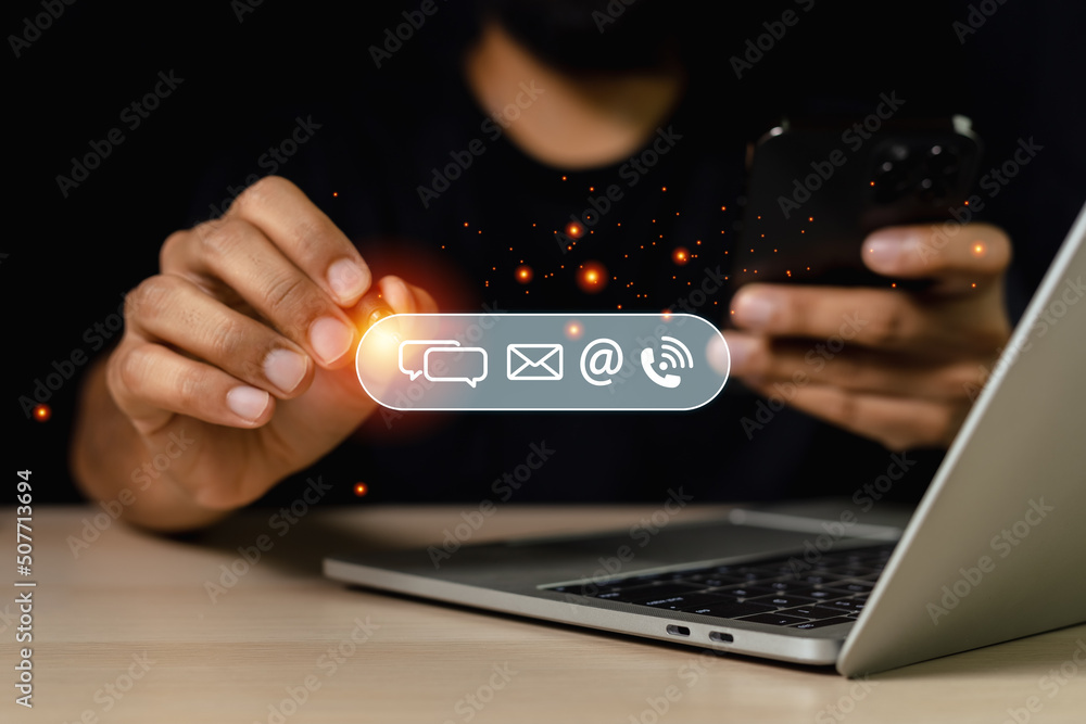 Concept of contact us. Man using laptop holding pen finger point at ...