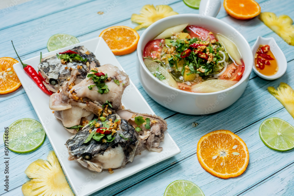 Vietnamese family food. Sour soup bowl of snakehead fish is rich in ...