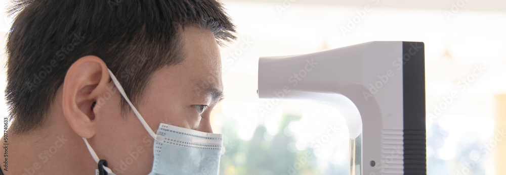 Man approached the forehead thermometer sensor to detect body heat ...