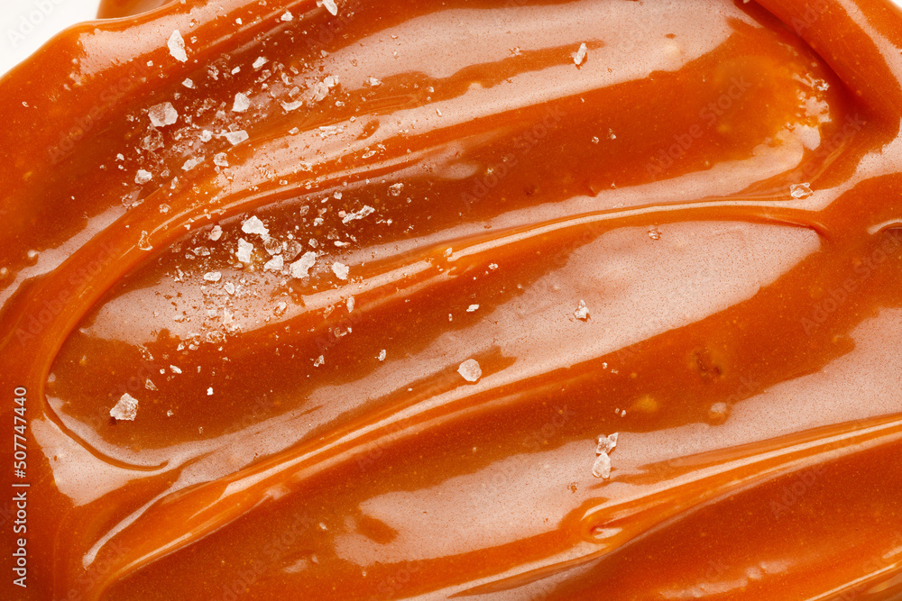 Liquid salted caramel syrup. Background of salted caramel paste ...