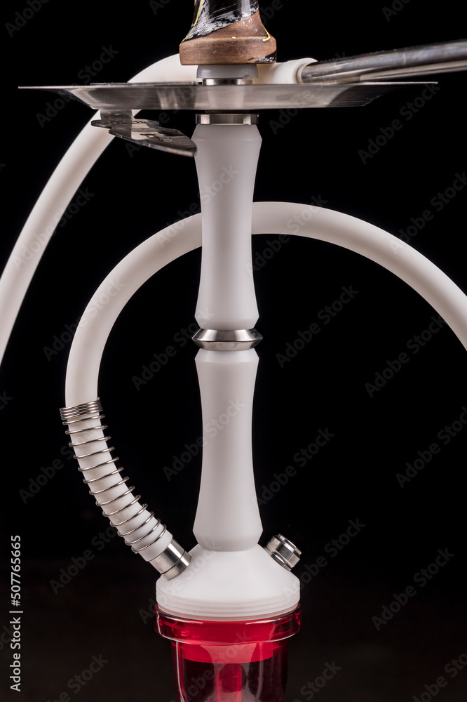 kolyan. on a black background. a vessel made of red glass and a white ...