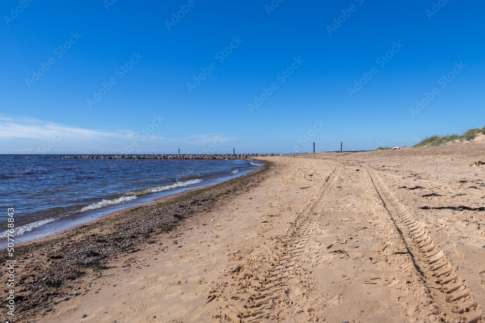 Tire prints on the beach of Baltic sea. Pier at beach in Tuja, Latvia ...