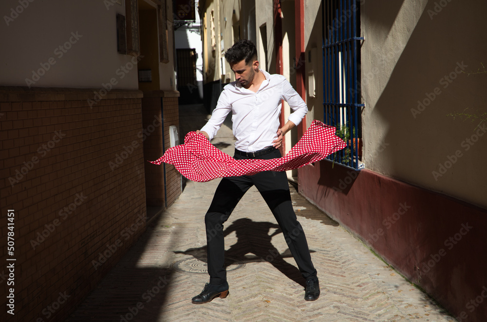 flamenco and gipsy man, dressed in black and white shirt dancing with a ...