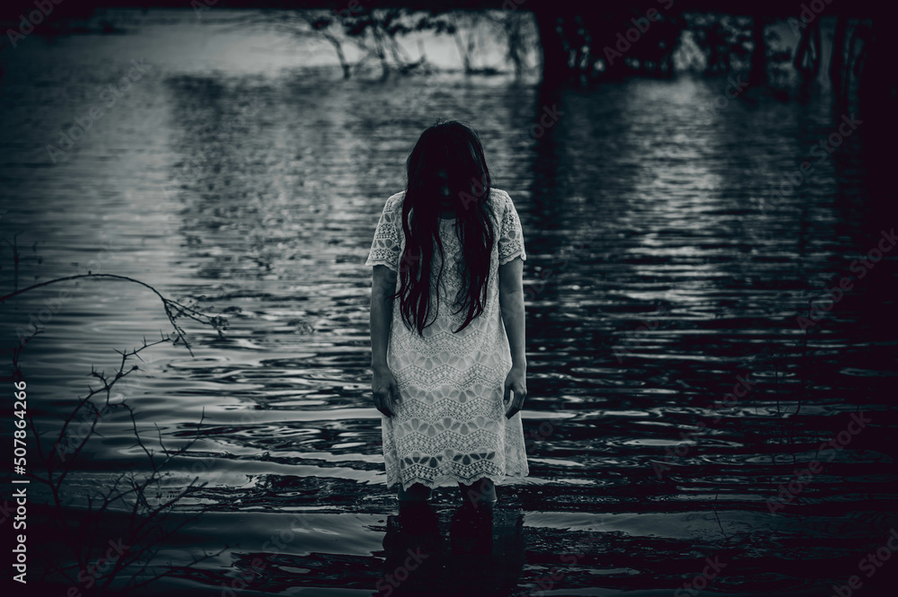 Portrait of asian woman make up ghost face at the swamp,Horror in water ...
