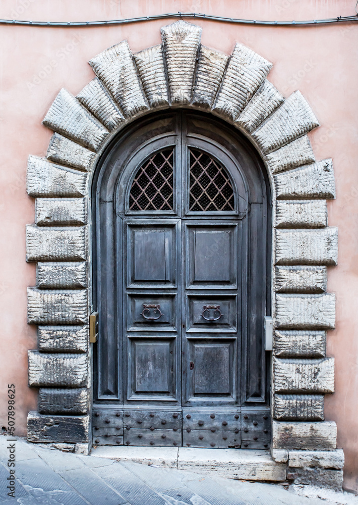 Vintage front door in the medieval city of Italy. Ancient wooden gate ...