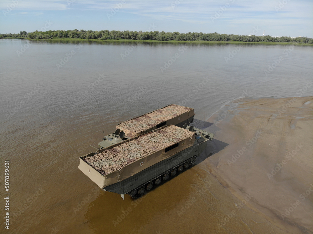 Russian military floating crawler transporters resting on the beach on ...