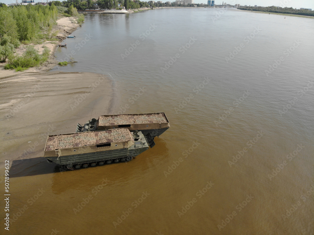 Russian military floating crawler transporters resting on the beach on ...
