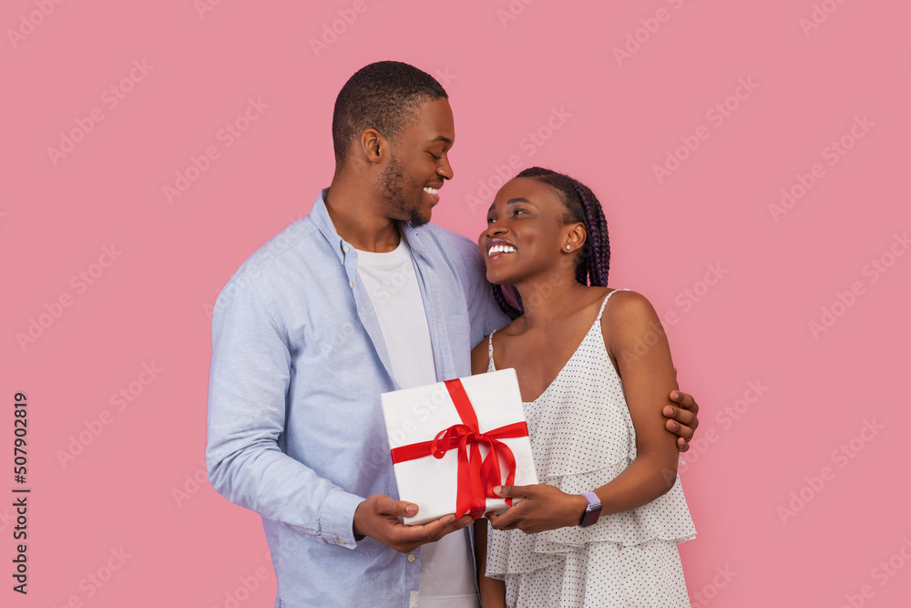 Happy black man making surprise for woman giving box Stock Photo ...