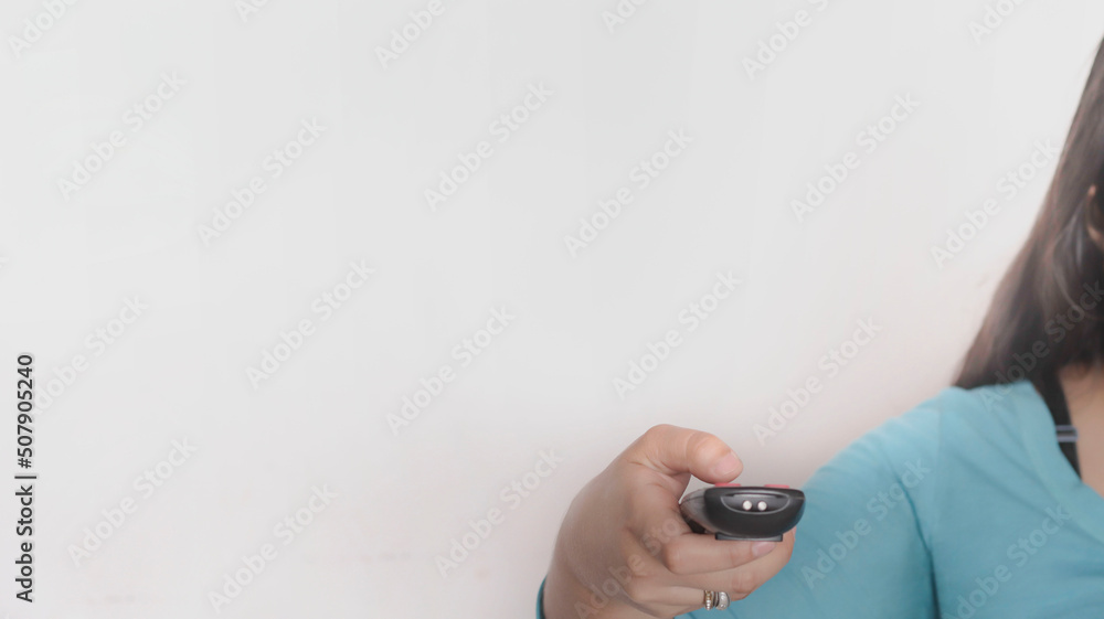 Hand changing channels with a remote control, with buttons and an ...