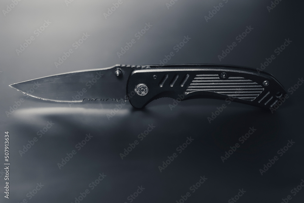Close up detail photo of a combat folding knife. Product design photo ...