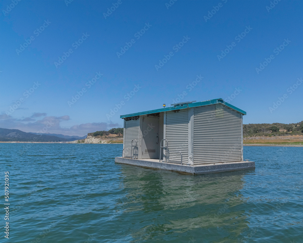 A Public floating restroom on a lake. Cliff swallows have built nests ...