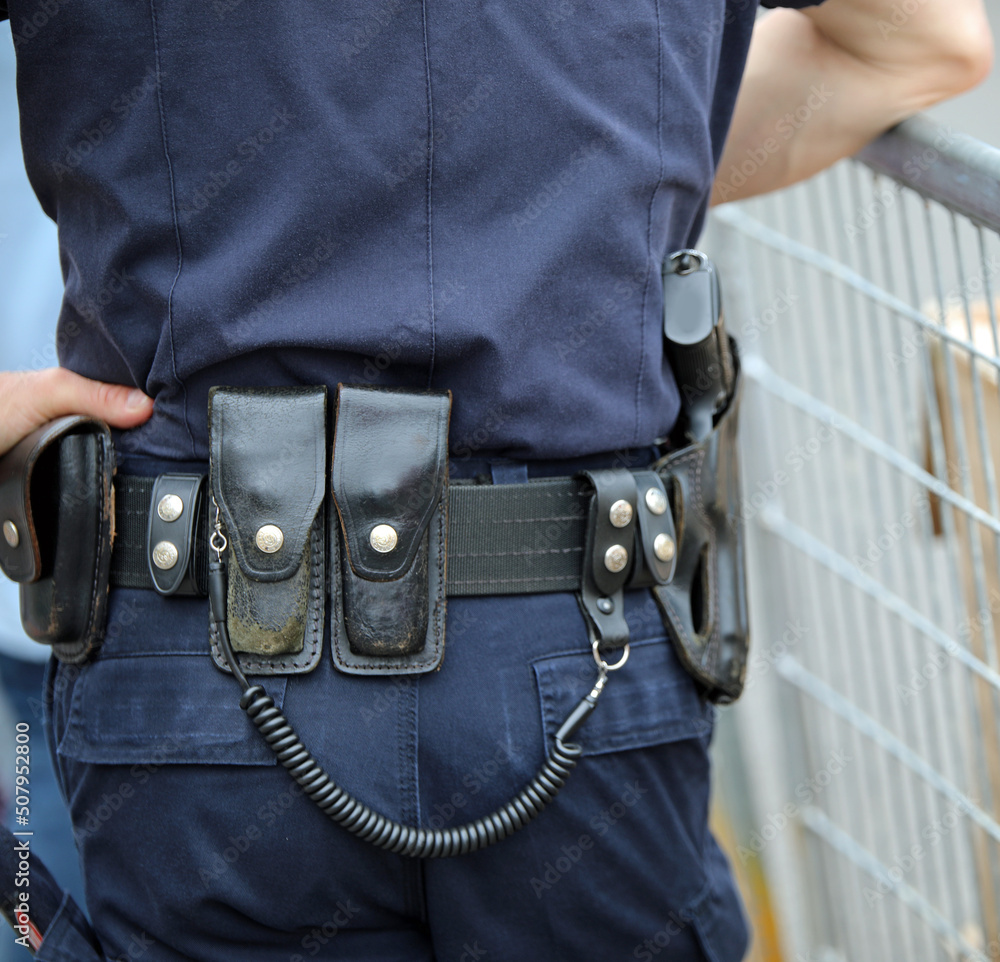 Security guard with guns and scabbard during surveillance outside the ...