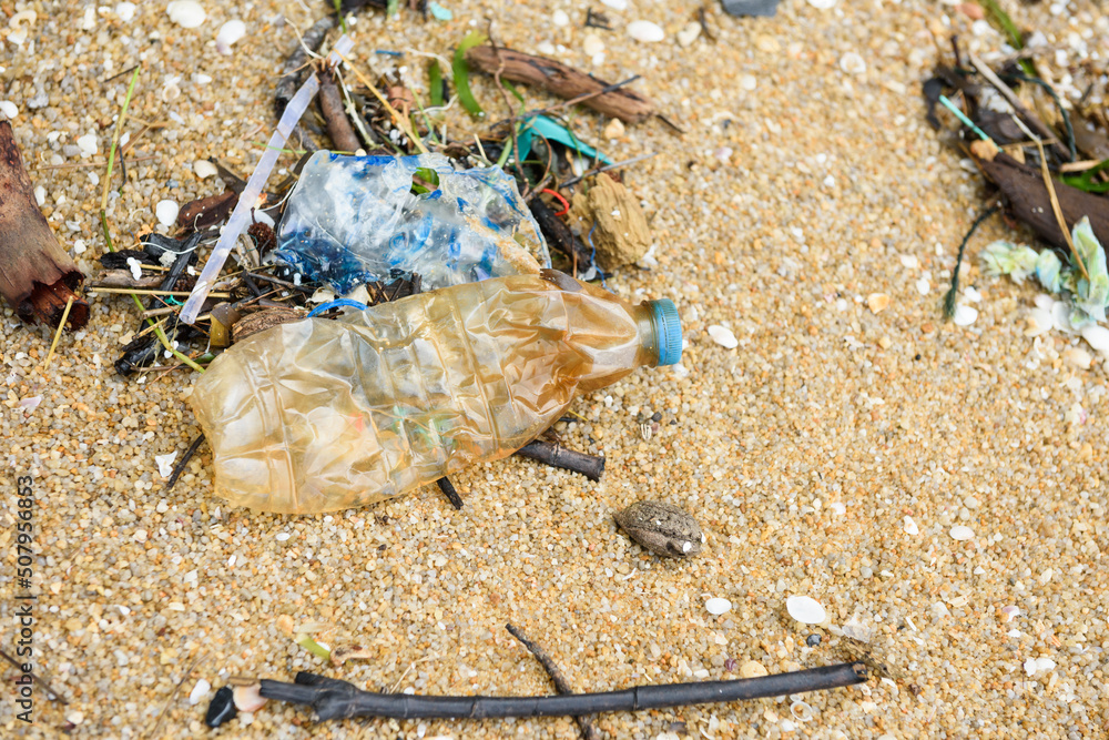 Plastic bottles and other trash on sea beach. Garbage on beach. Plastic ...
