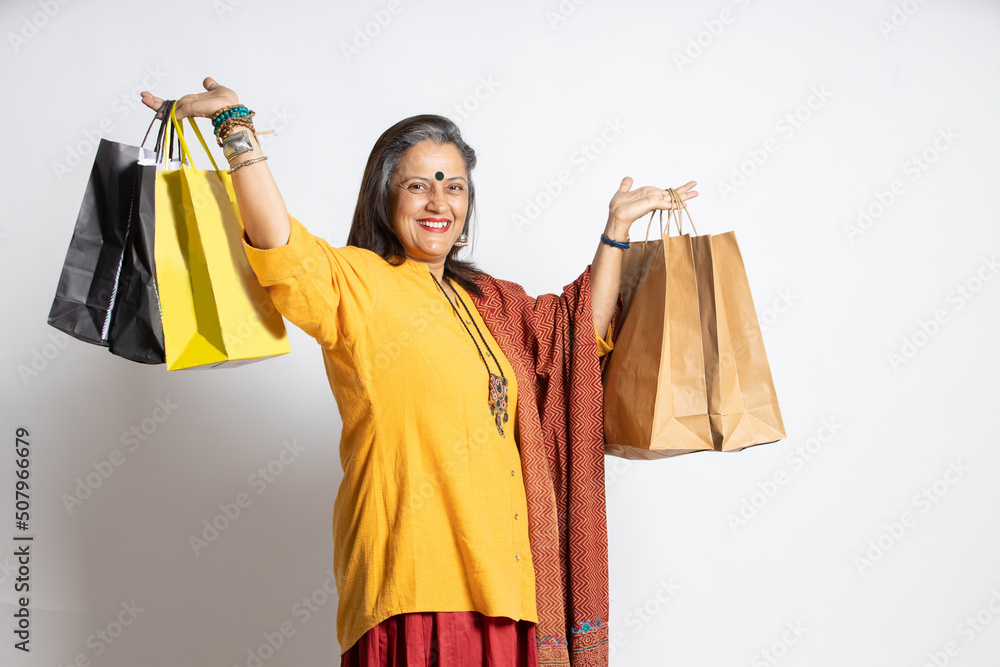 Happy excited indian senior mature woman holding shopping bags. elderly ...