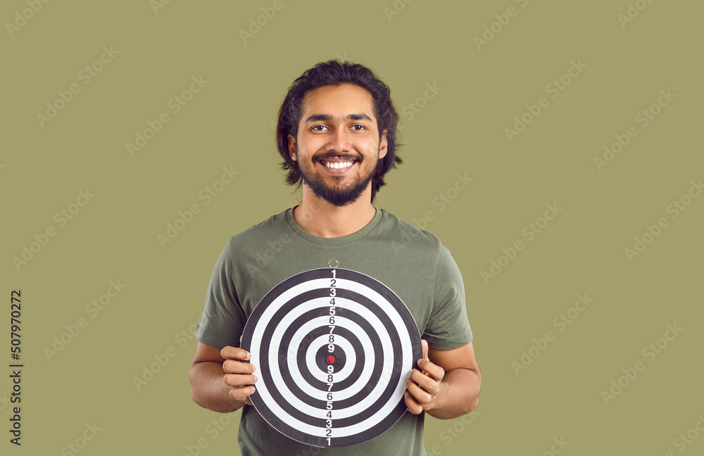 Portrait of happy ethnic man holding shooting target and smiling ...