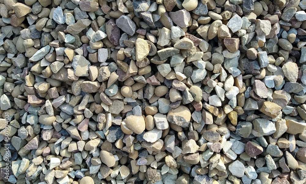 A closeup of a pile of loose rough stones taken at a stone pit. The ...