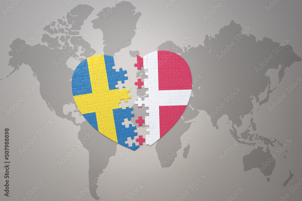puzzle heart with the national flag of sweden and denmark on a world ...