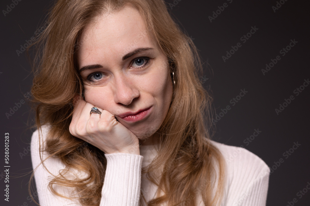 Portrait of thoughtful, dissatisfied, pensive young woman. Blong girl ...