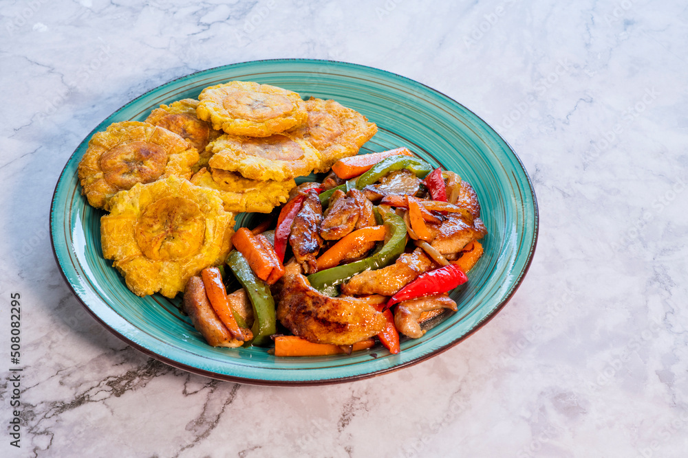 Chopped steak or Bistec Picao and patacones or tostones are fried green ...