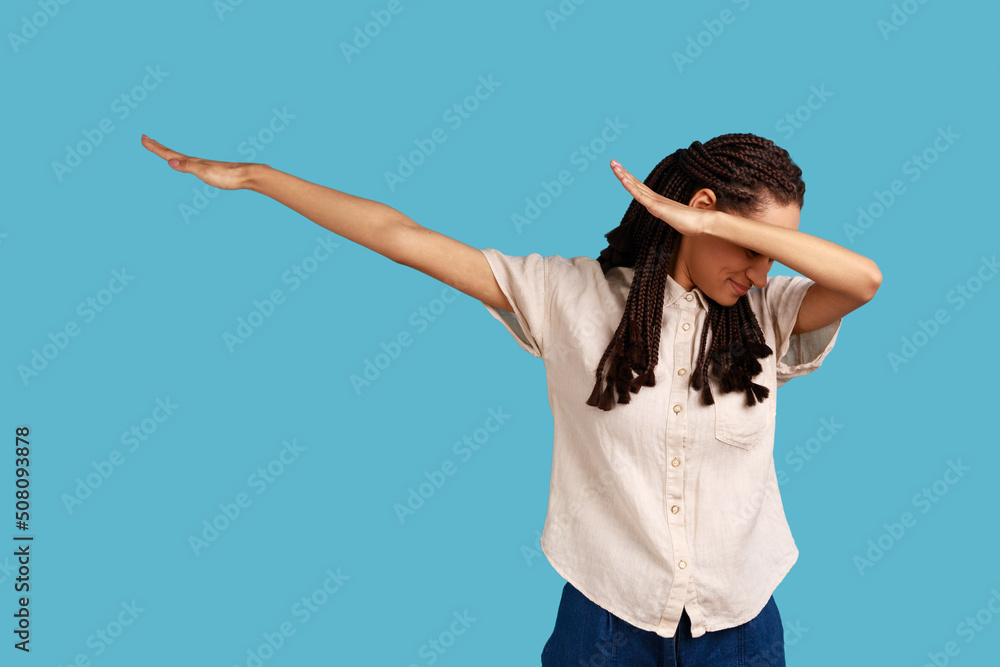 Portrait of happy woman with black dreadlocks showing dab dance ...