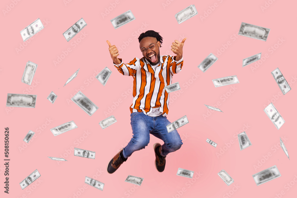 Money rain, winner and rich. Hurray. full length happy man jumping with ...
